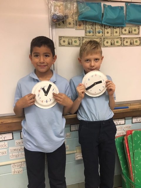 2nd Graders using clocks in math class – St. Linus School